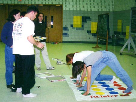 A bunch of people playing Twister, I wonder who that is?